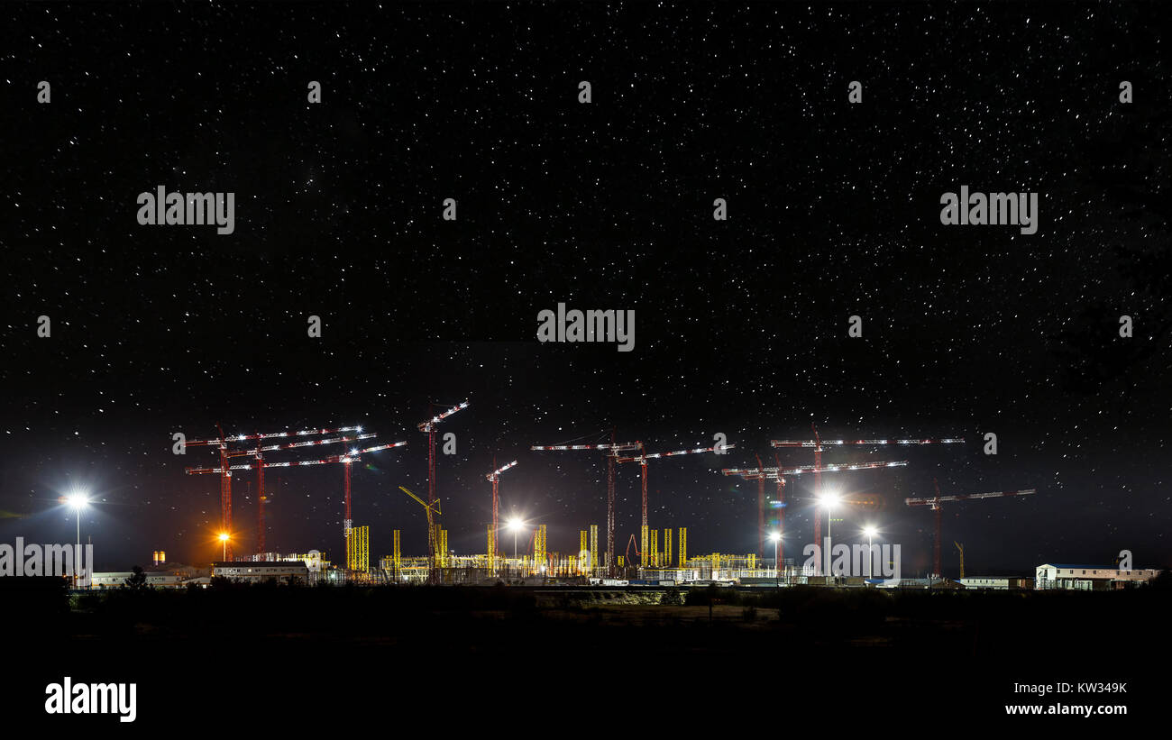 Cranes at construction site, night panorama starry sky Stock Photo - Alamy