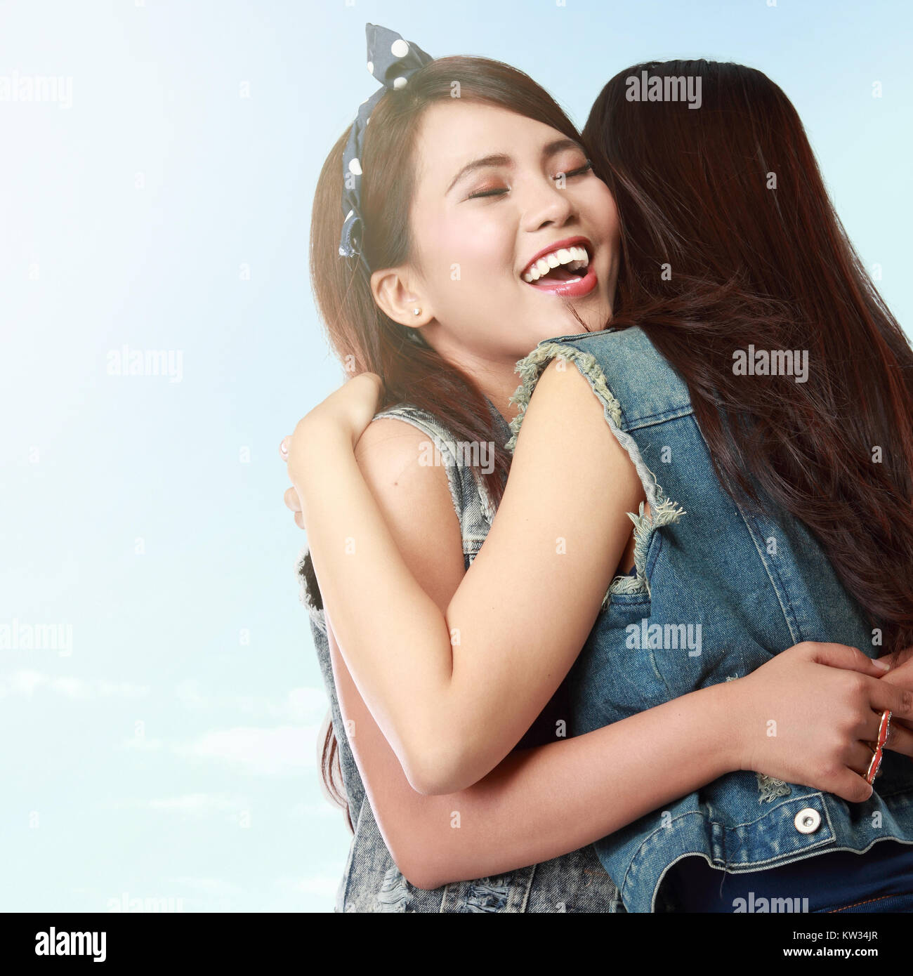 Two women hugging Stock Photo - Alamy