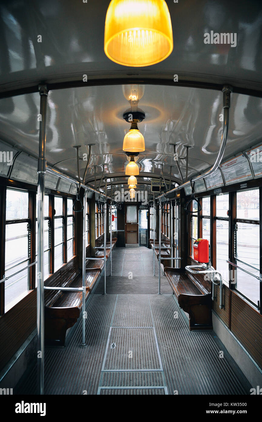 Interior view of classic Milan tram with wooden seat and machined glass ...