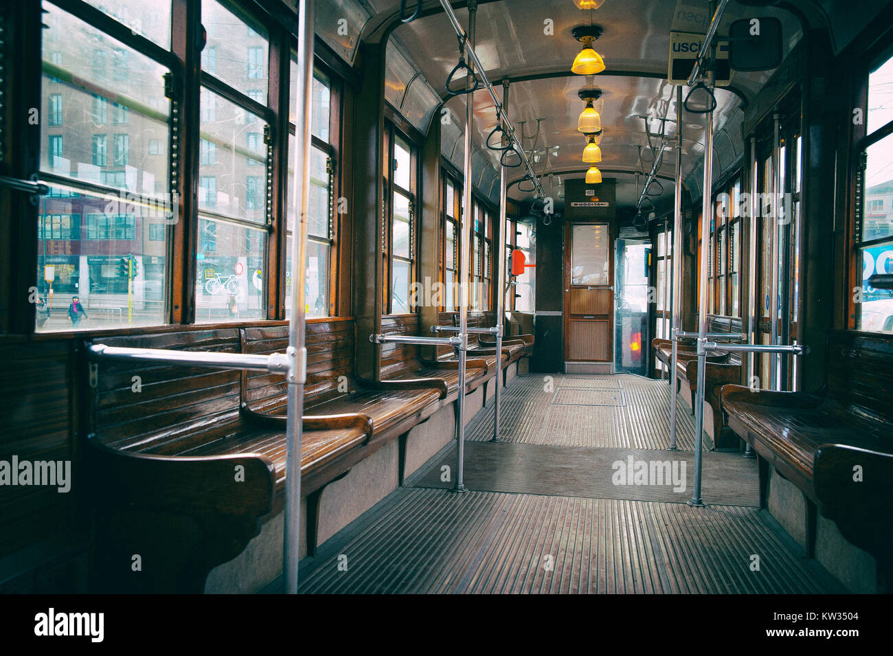 Interior view of classic Milan tram with wooden seat and machined glass ...
