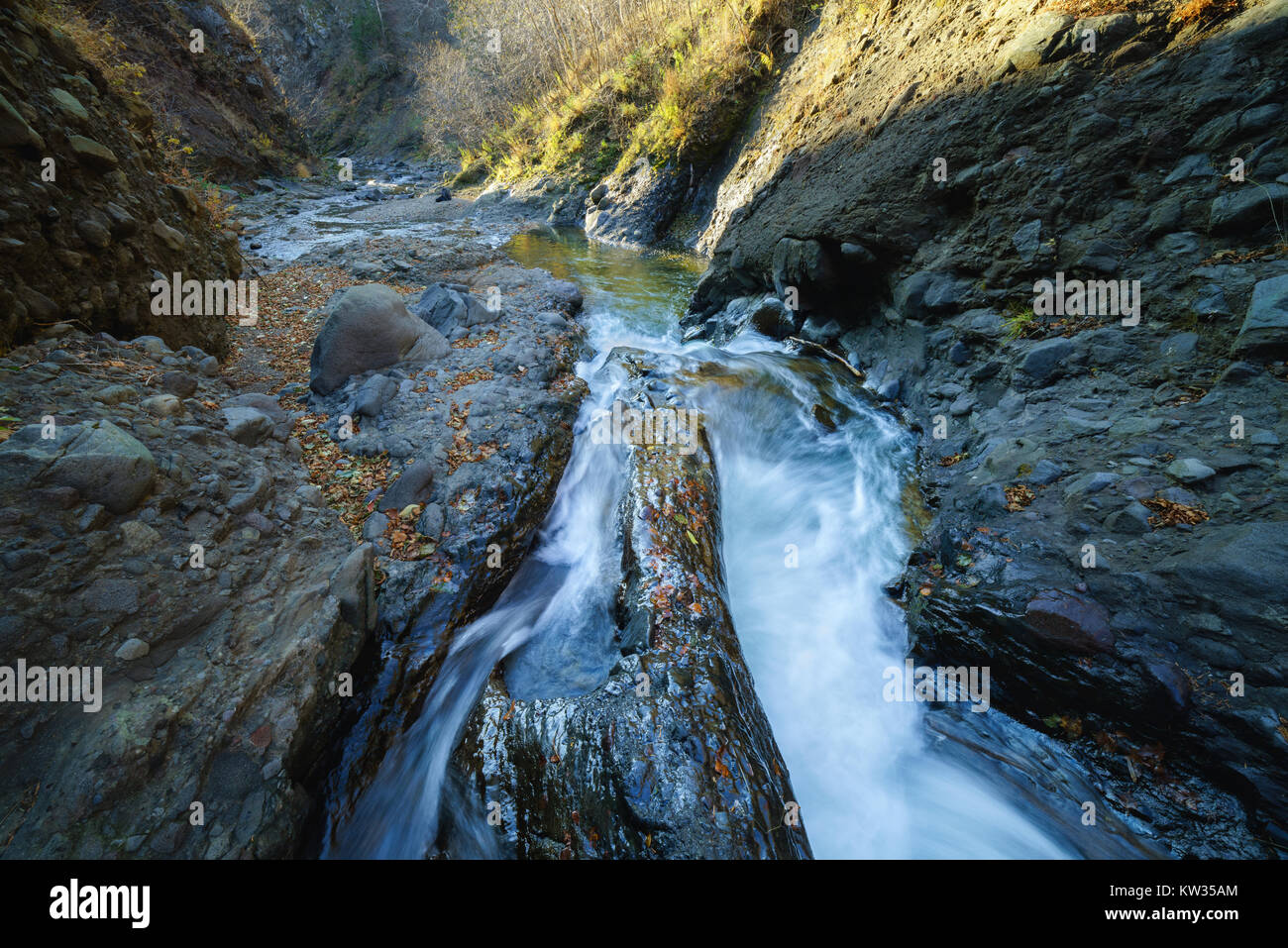 Mountain river with small canyons and waterfalls in late autumn with ...