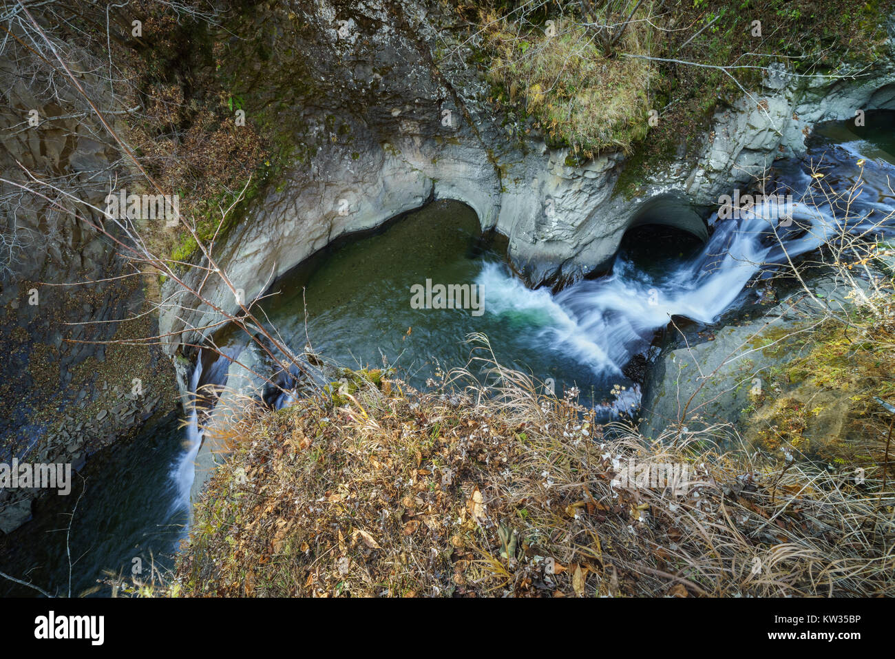 Mountain river with small canyons and waterfalls in late autumn with ...