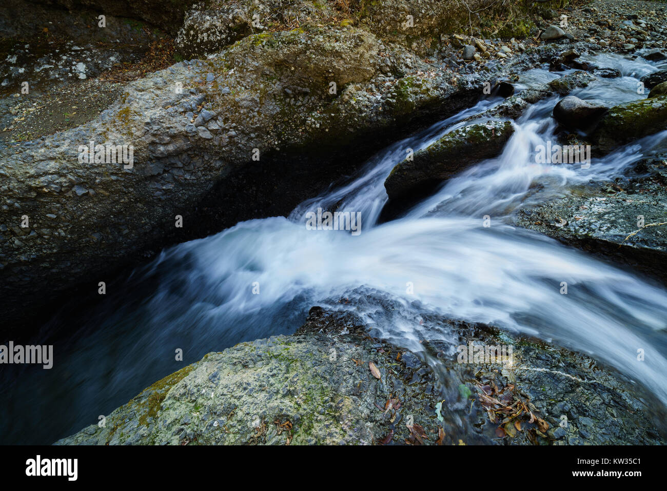 Mountain river with small canyons and waterfalls in late autumn with ...