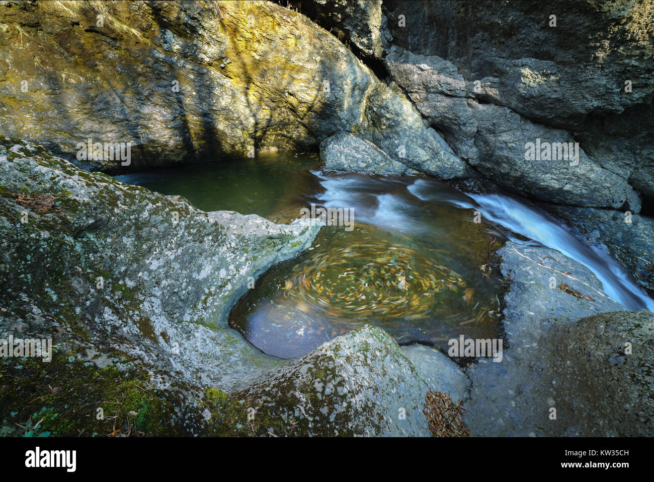 Mountain river with small canyons and waterfalls in late autumn with ...