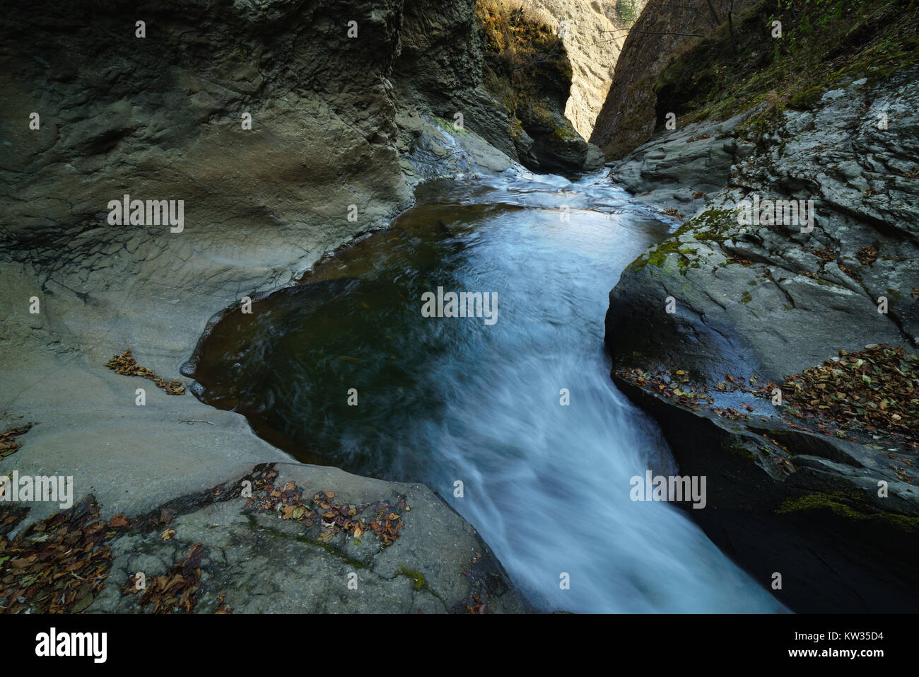 Mountain river with small canyons and waterfalls in late autumn with ...