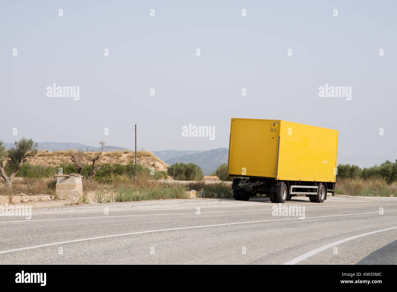 Yellow box road-trailer in a lay-by Stock Photo - Alamy