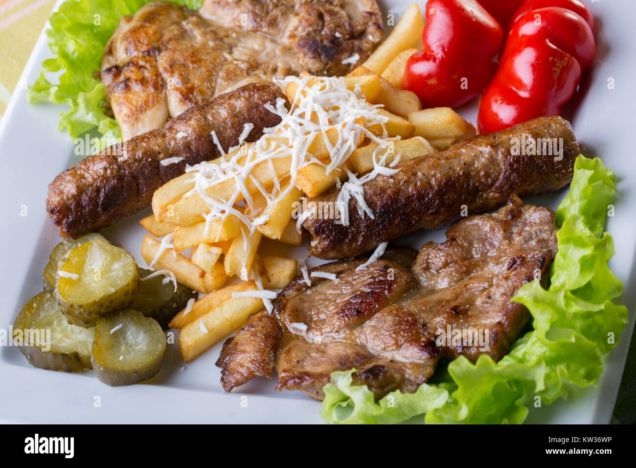 close up of traditional pork mix with fries Stock Photo - Alamy