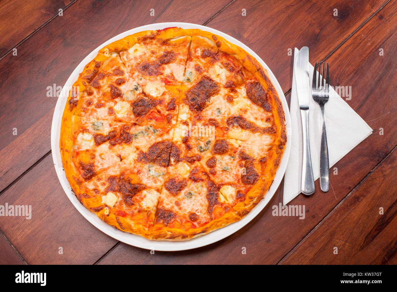 Four cheese pizza top view with wooden table Stock Photo - Alamy