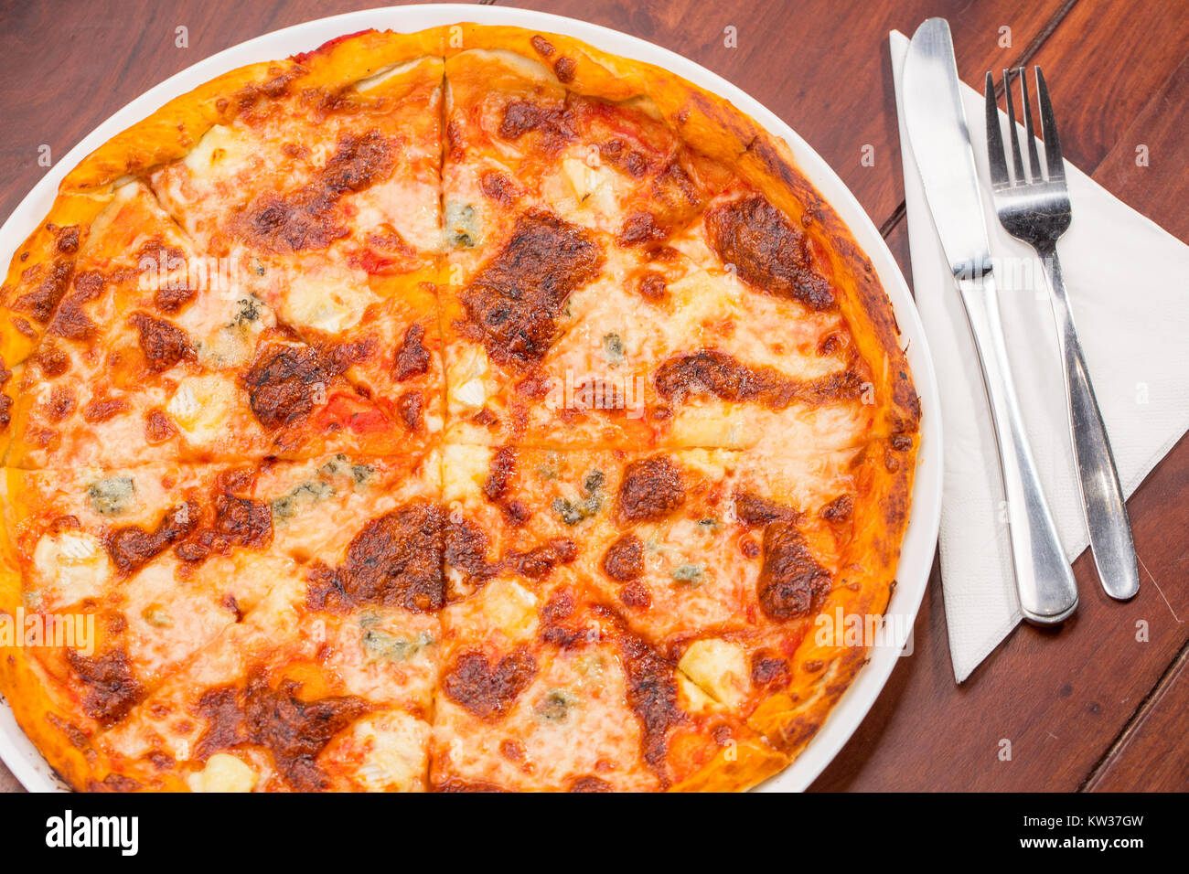 Four cheese pizza top view with wooden table Stock Photo - Alamy