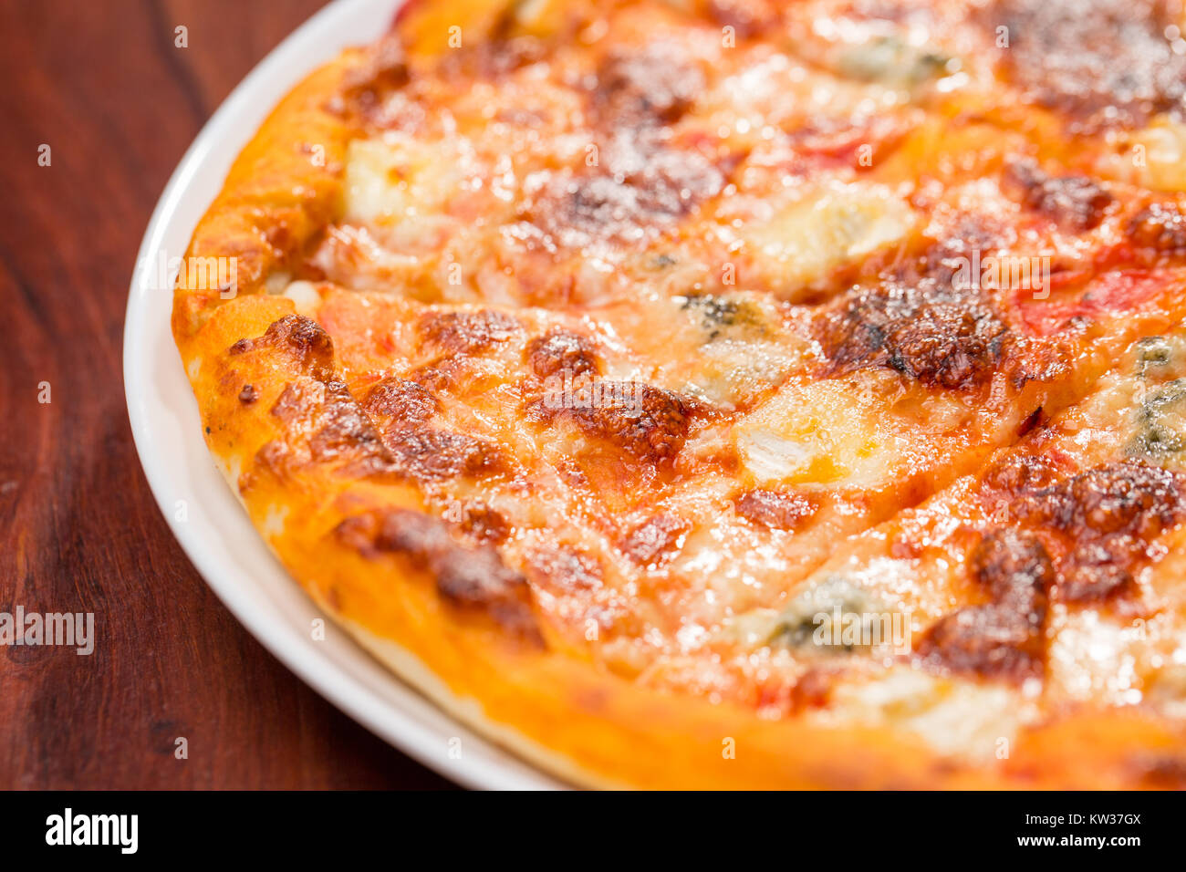 Four cheese pizza top view with wooden table Stock Photo - Alamy