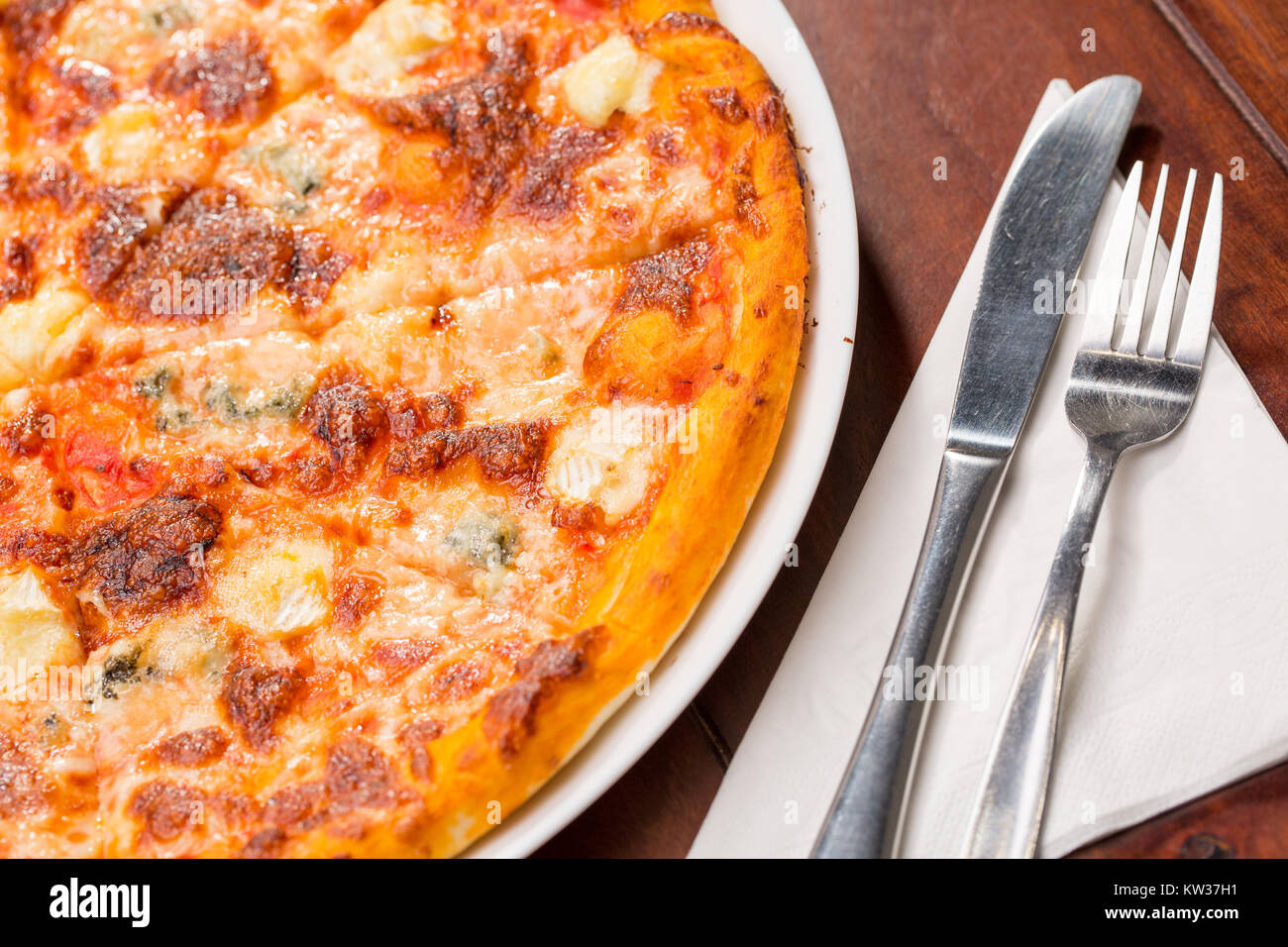 Four cheese pizza top view with wooden table Stock Photo - Alamy