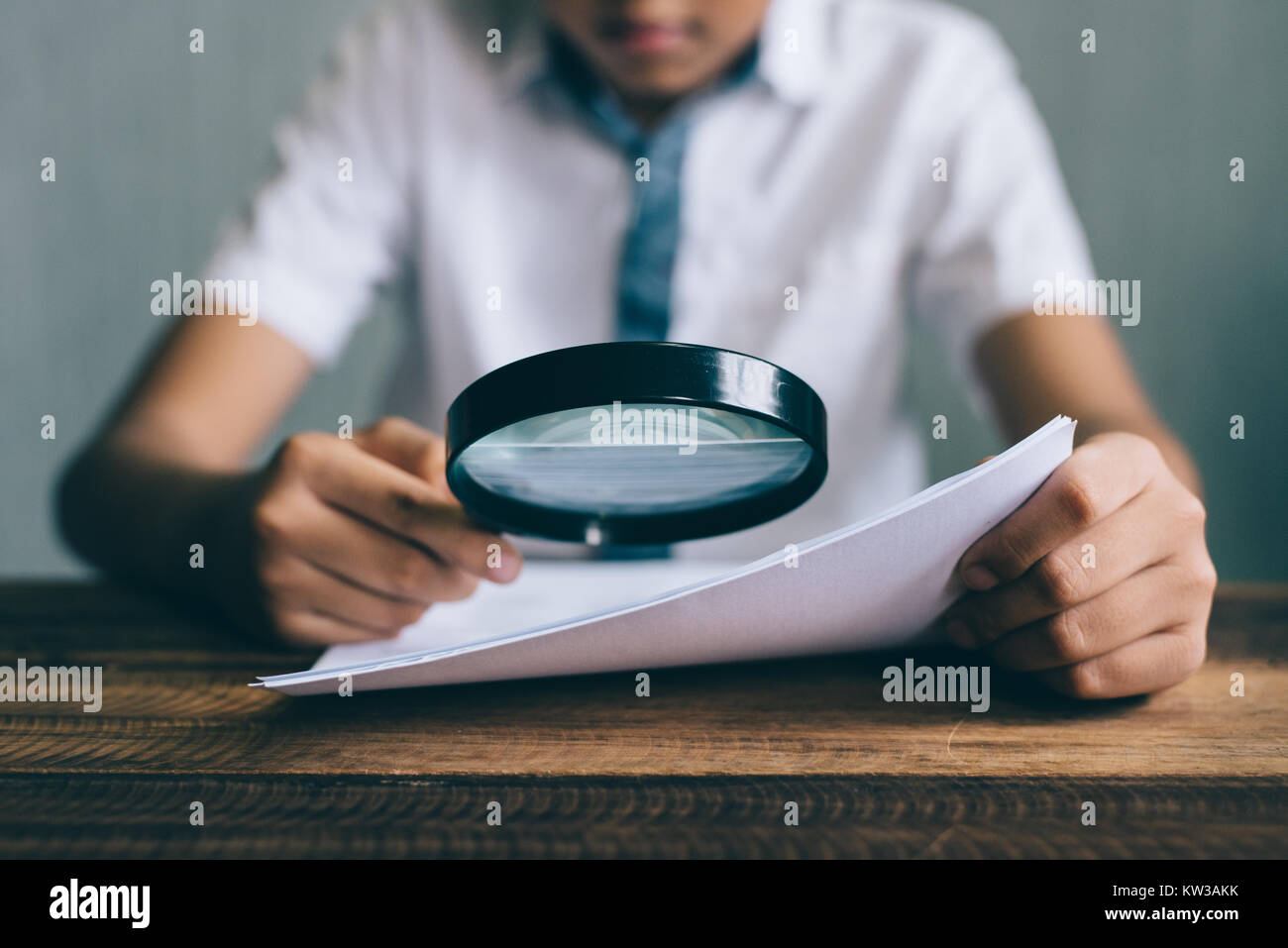 asian boy student looking at paper using magnifying glass. education ...