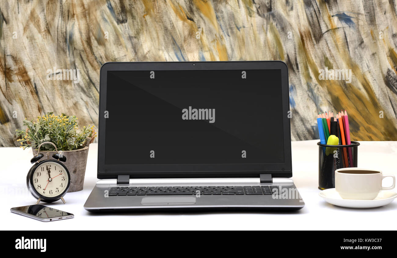Laptop on Office Table with Coffee and clock Stock Photo - Alamy