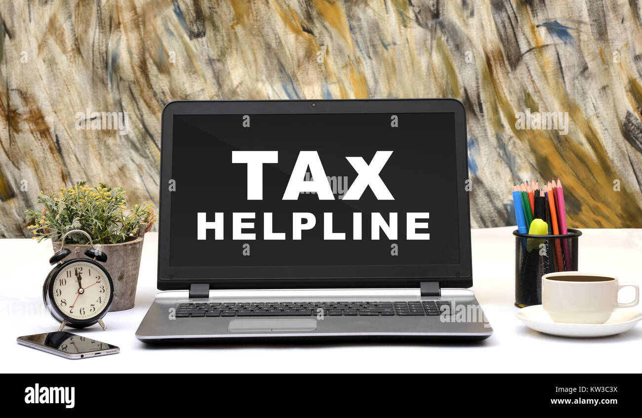 Tax Helpline on laptop screen with office supplies Stock Photo - Alamy