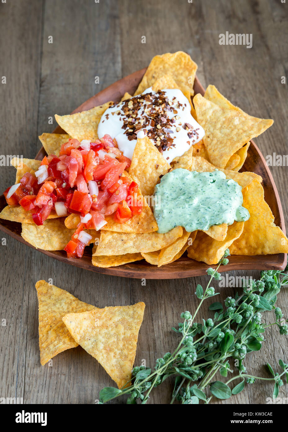 Cheese nachos with different types of sauce Stock Photo - Alamy