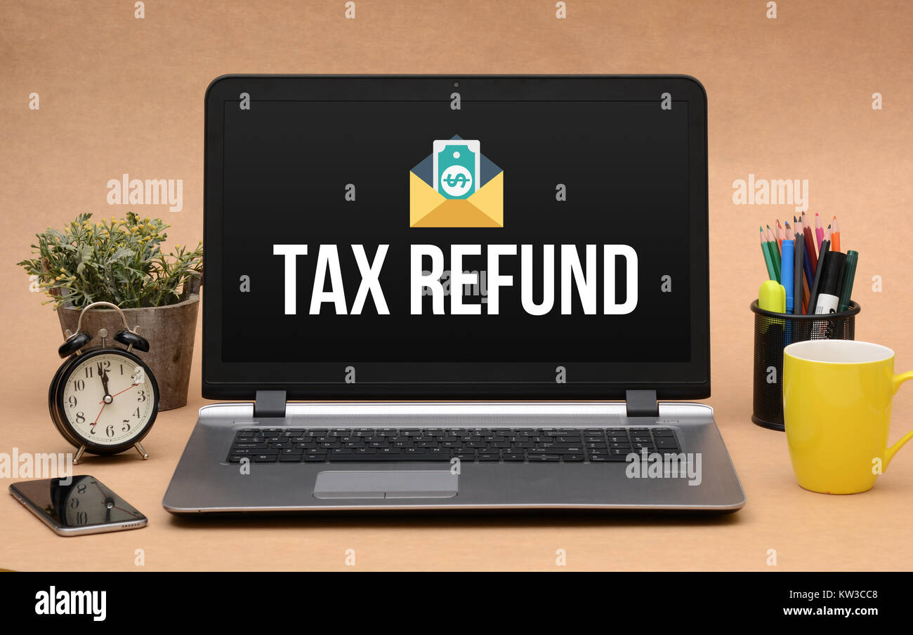 Tax Refund Icon on Office Laptop Screen Stock Photo - Alamy