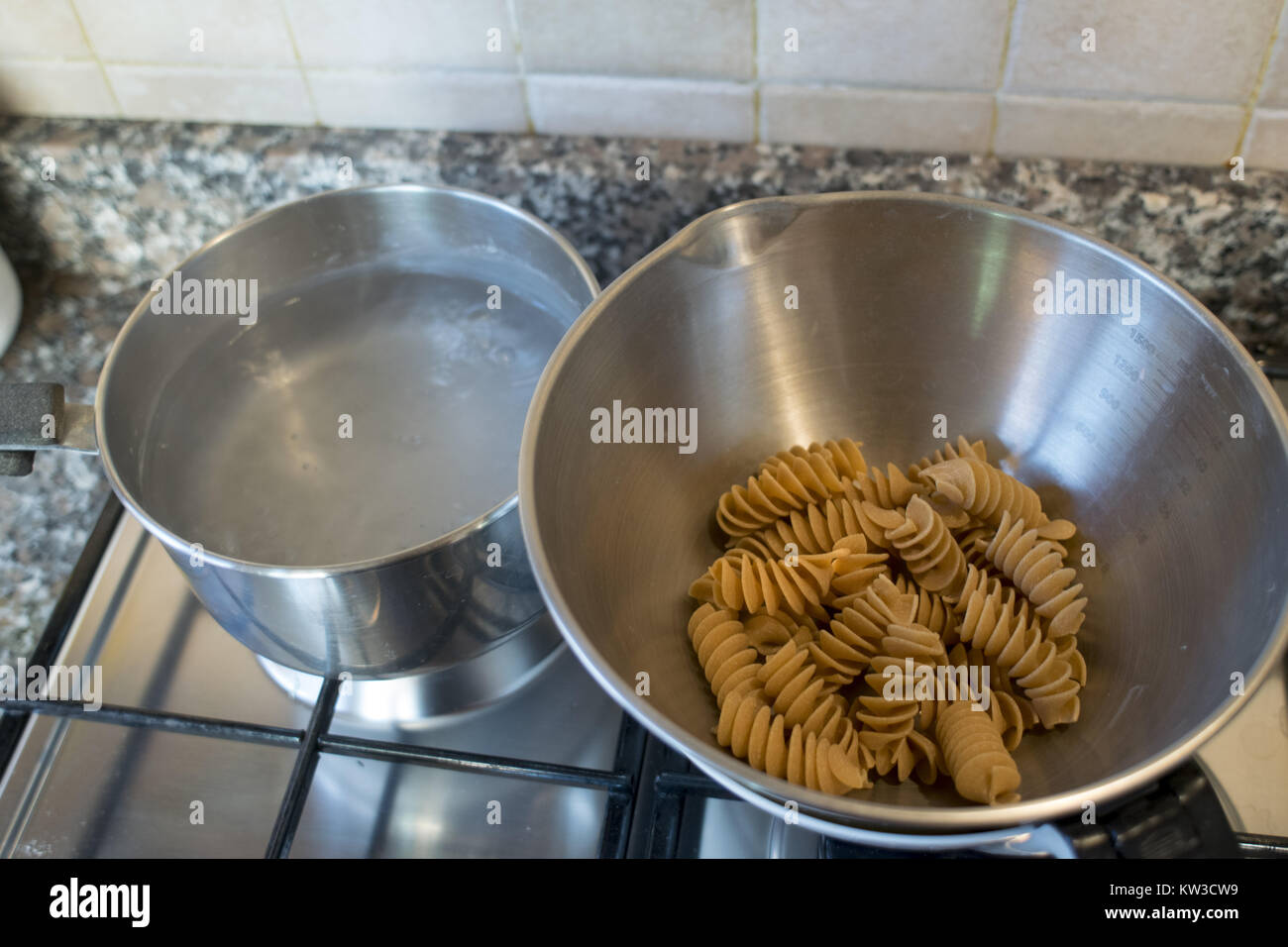 boiling water in pan to prepare wholemeal pasta Stock Photo - Alamy