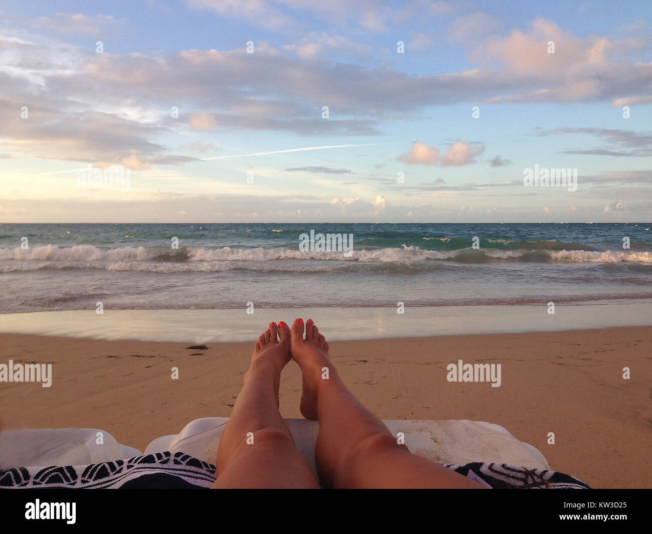 Sunbathing on a beach Stock Photo - Alamy