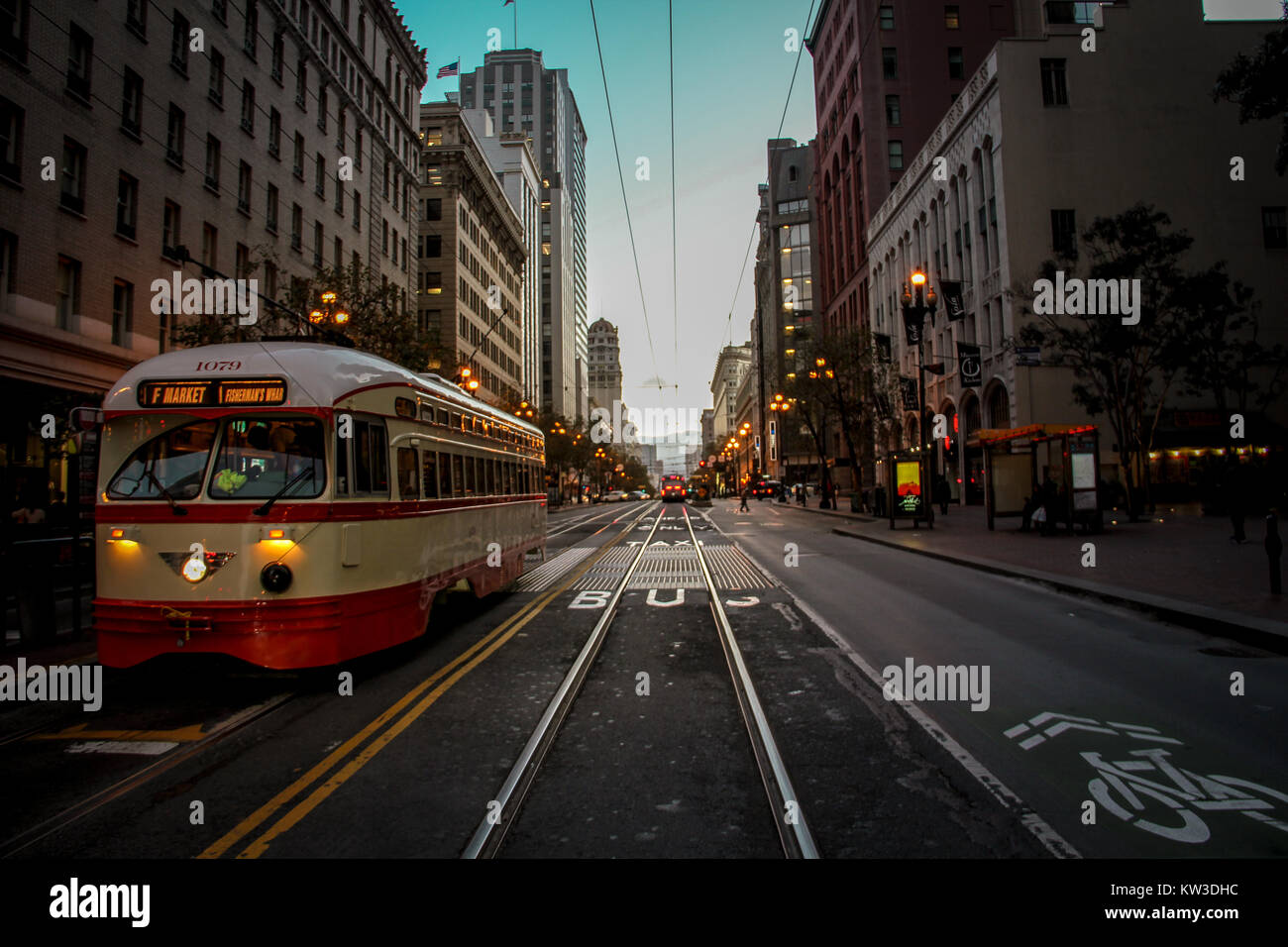 Typical street scene in San Francisco with cable car at sunset Stock ...