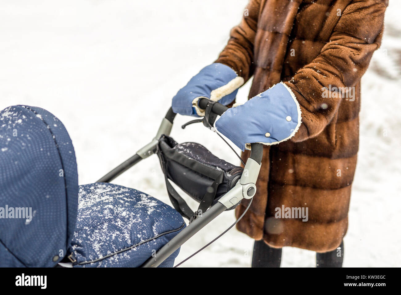Womans hand in a warm sheepskin mittens Stock Photo - Alamy