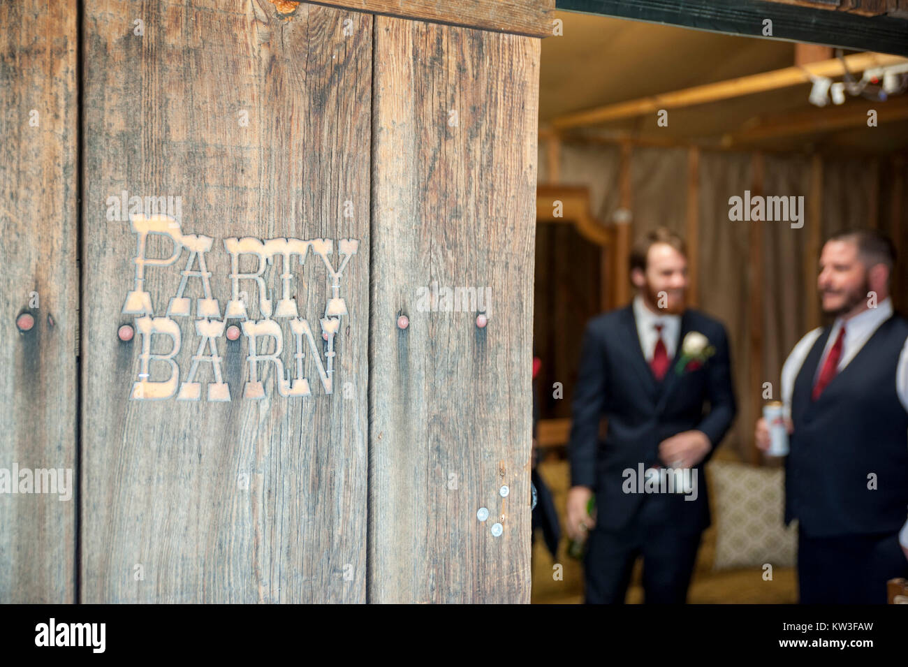Rustic Door etched with "Party Barn" - partying groomsmen in background ...
