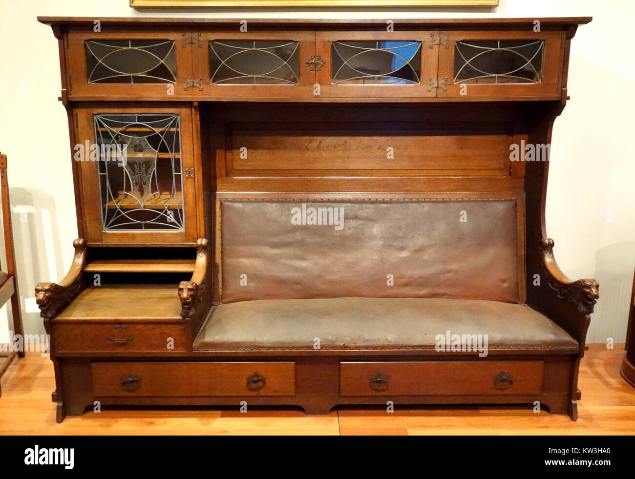 This bookcase settle, designed by Frederick H. Meyer and crafted by ...