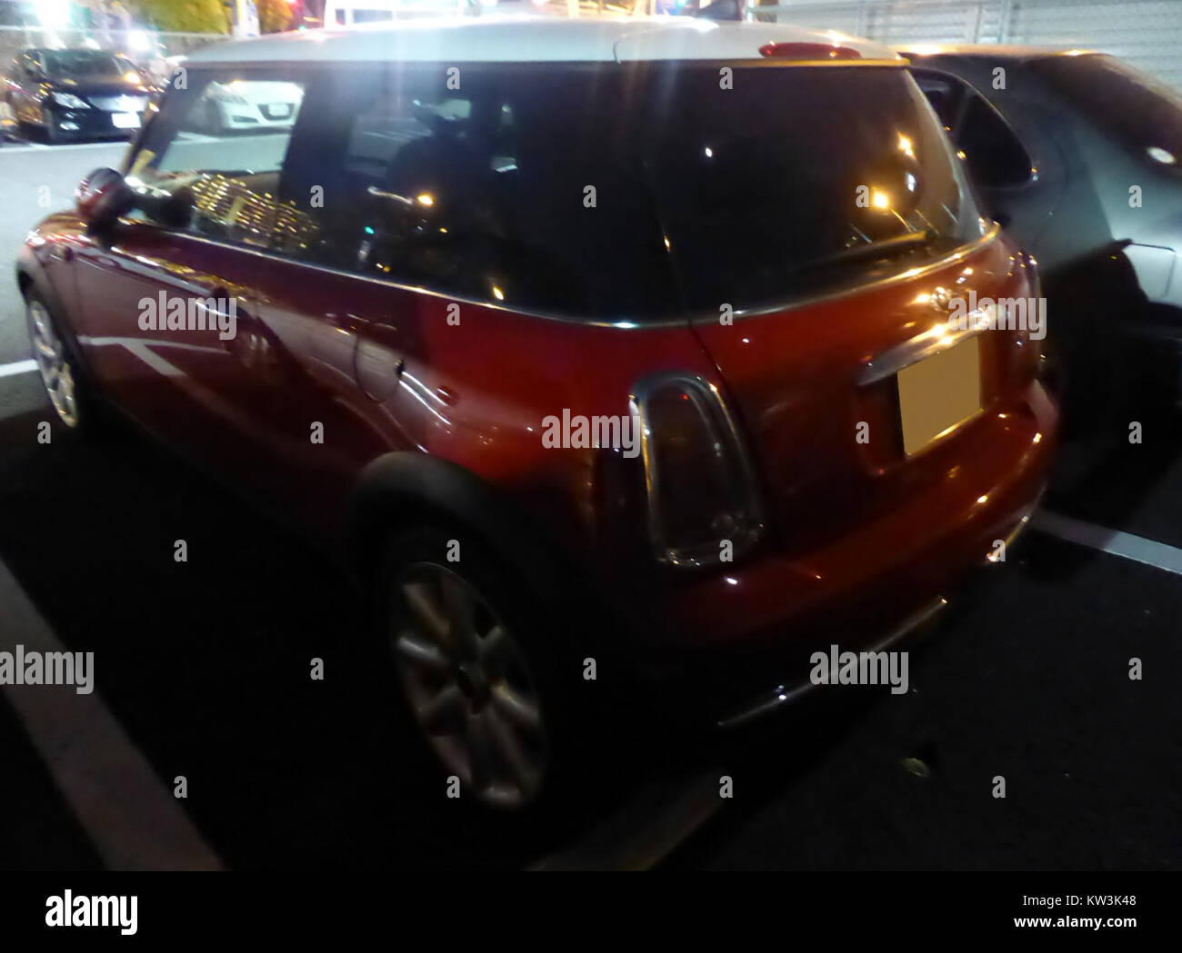 The BMW MINI Cooper (R50) is shown in a rear view at night ...