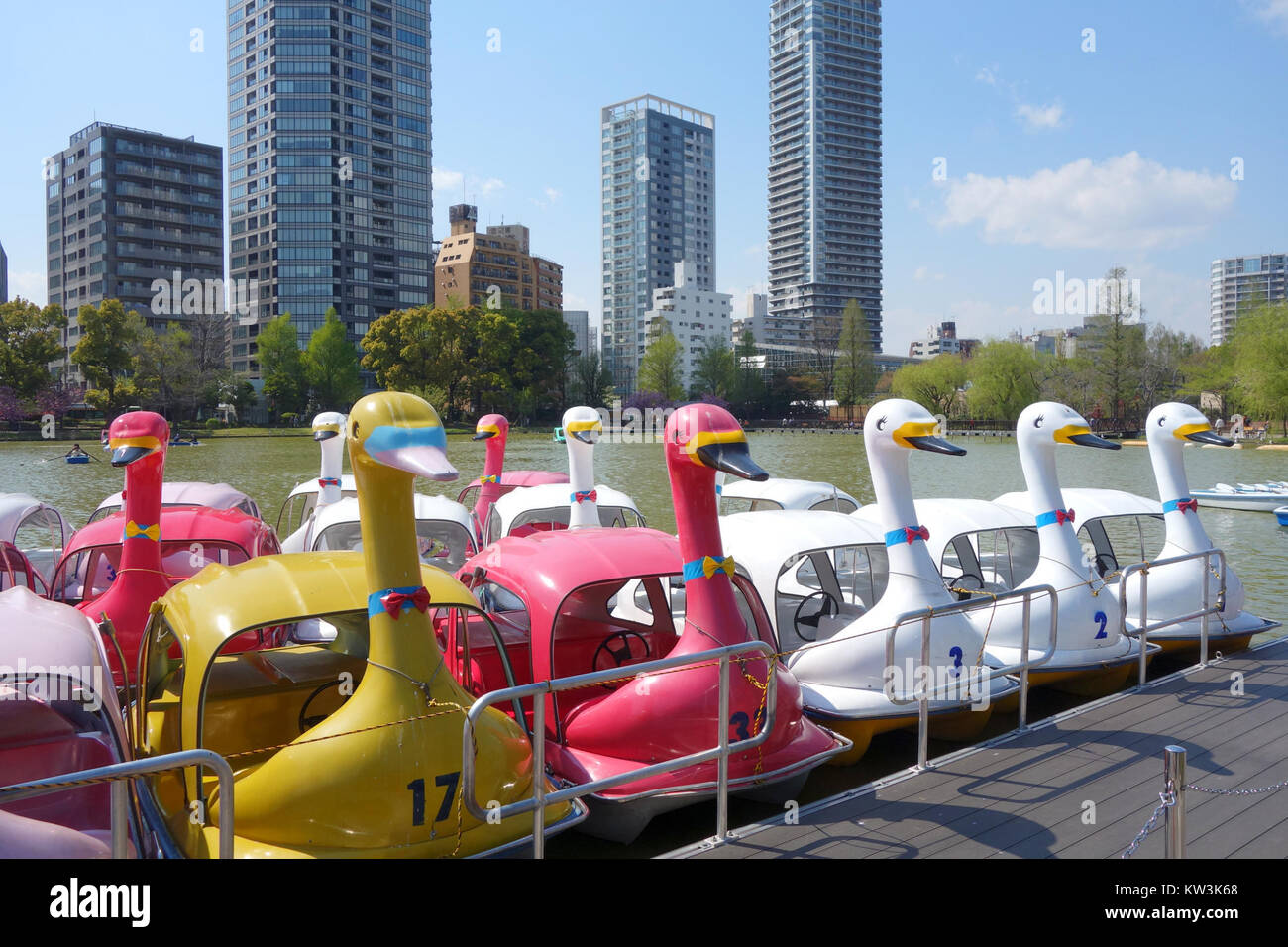 This image captures the serene scene of boats on Shinobazu Pond in Ueno ...