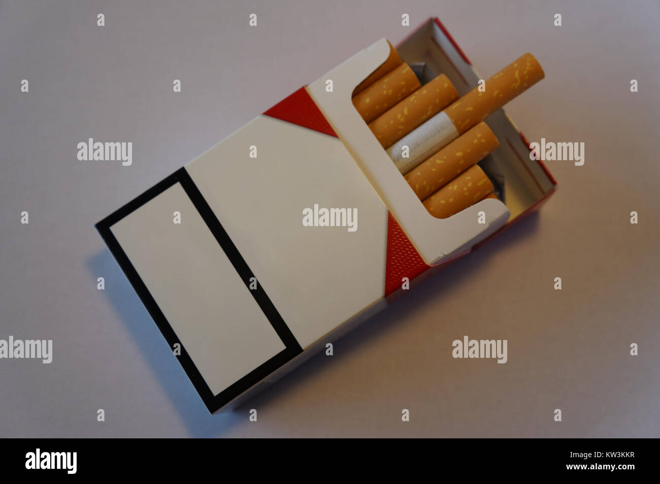 A blank cigarette packet with its logo removed, displaying cigarettes ...