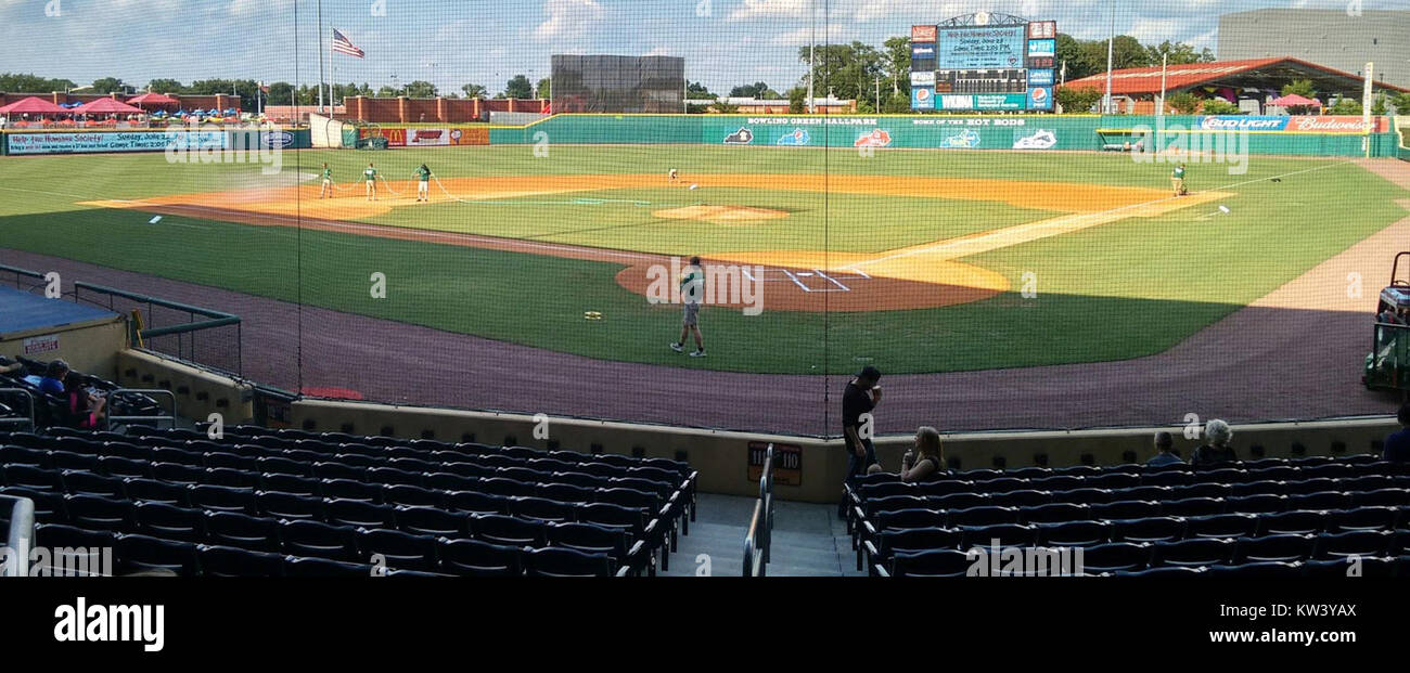 This photograph captures the view from behind home plate at a baseball ...