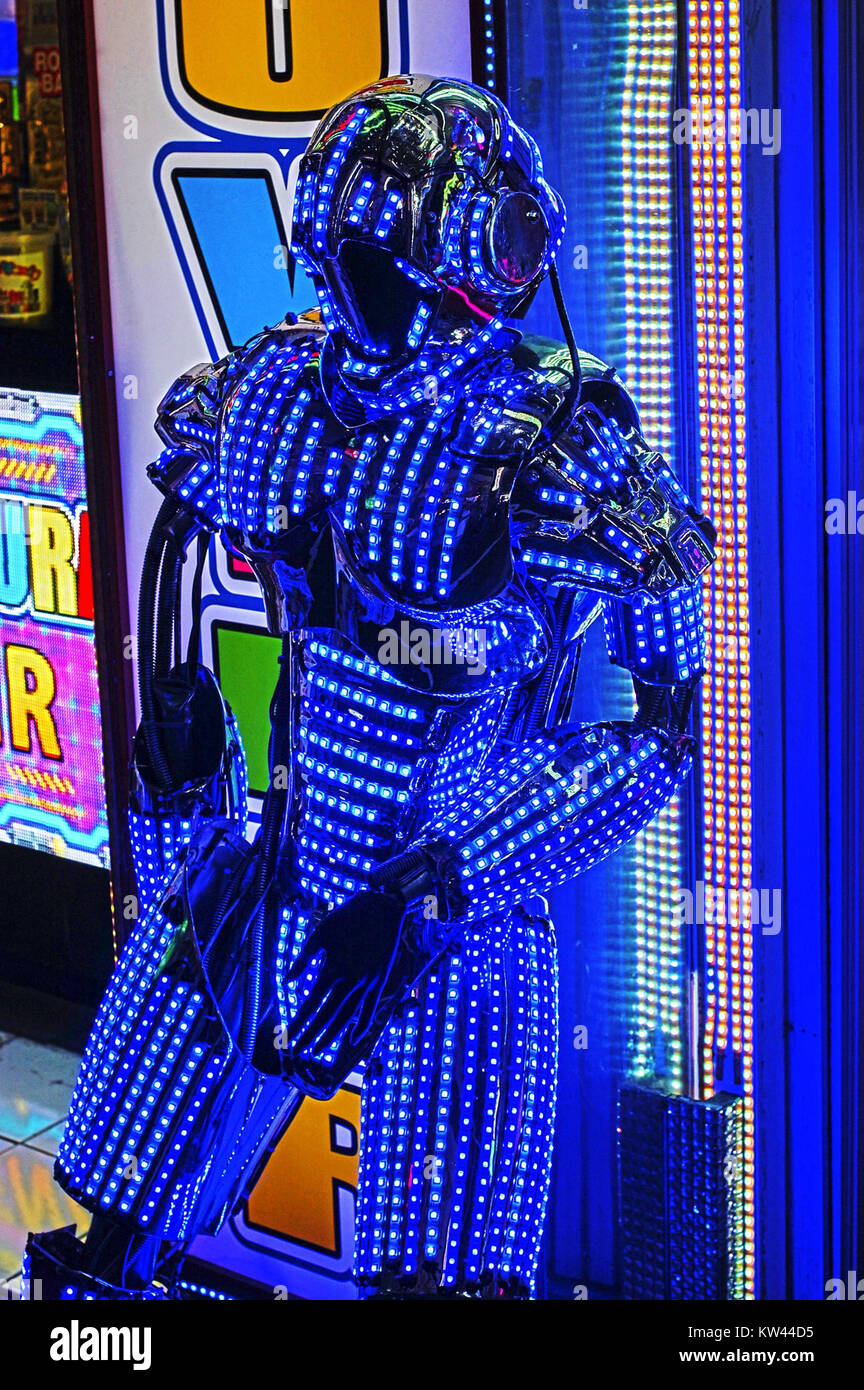 This image features a blue illuminating robot at night in Japan ...