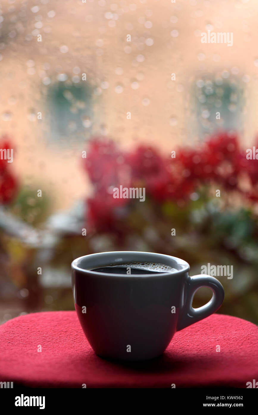 Cup of Hot Coffee in front of window raindrops Stock Photo - Alamy