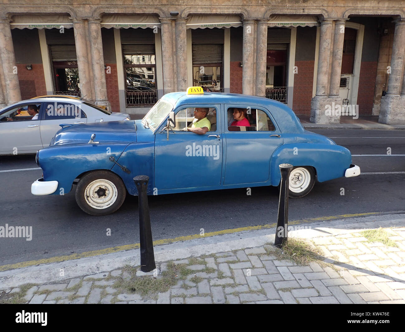 A classic blue taxi in Havana, Cuba, represents the unique charm of the ...
