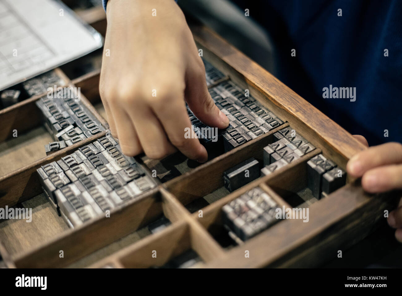 Children learning how to set printers type on a letterpress course ...