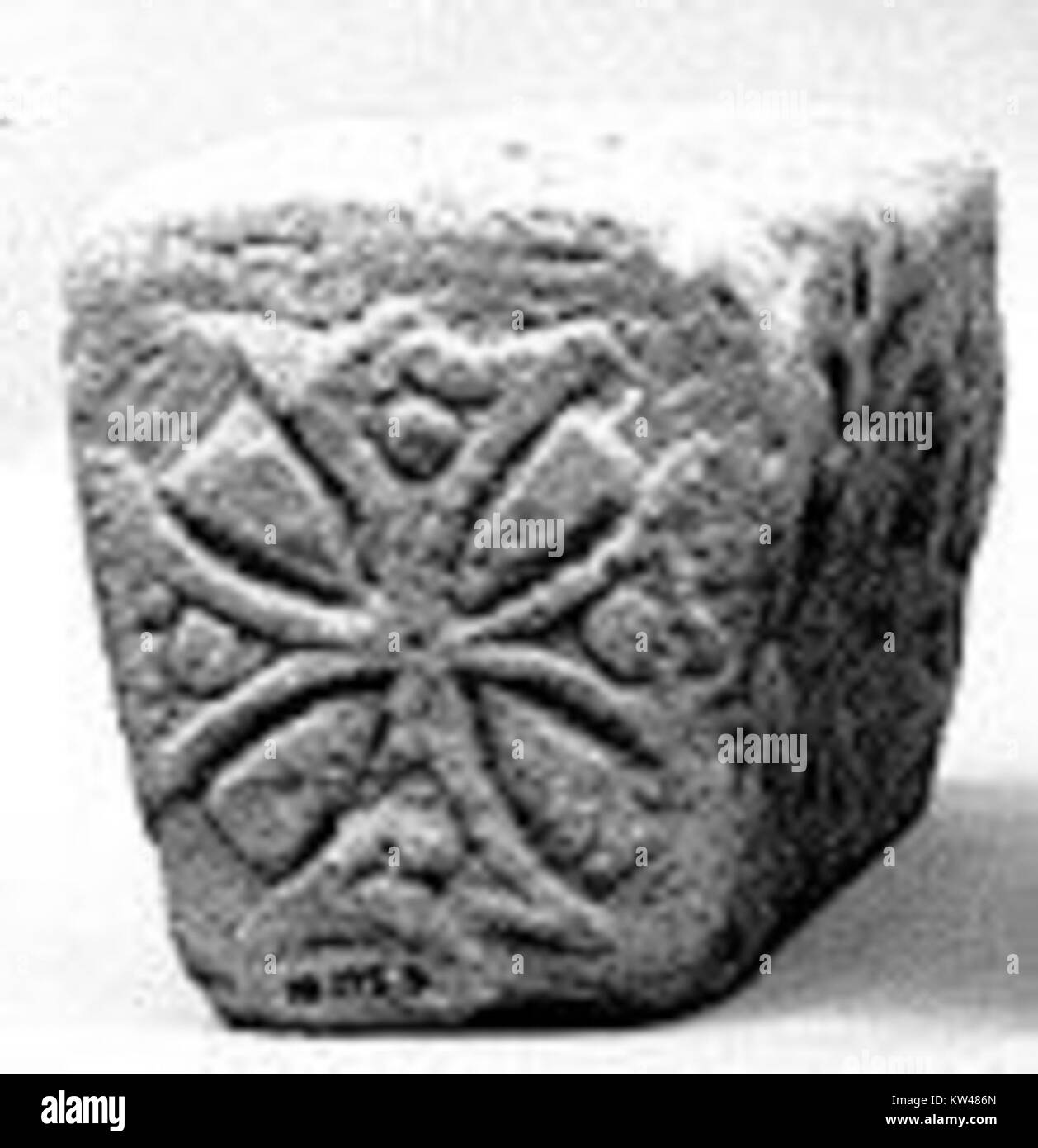 This artifact, 'Block from an Arch with a Cross,' is a historical stone ...