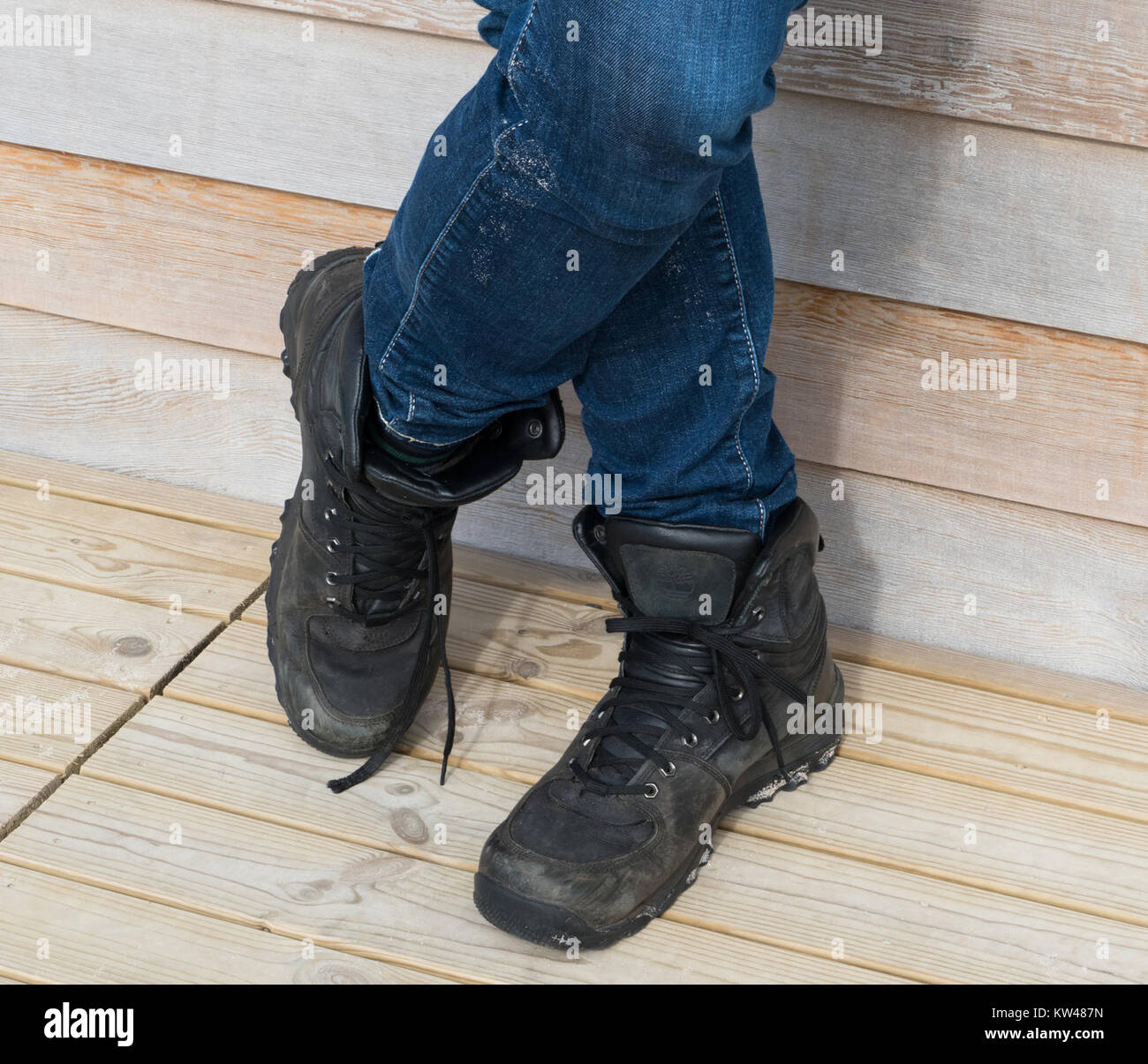 This image features the boots of a man, focusing on the footwear as a ...