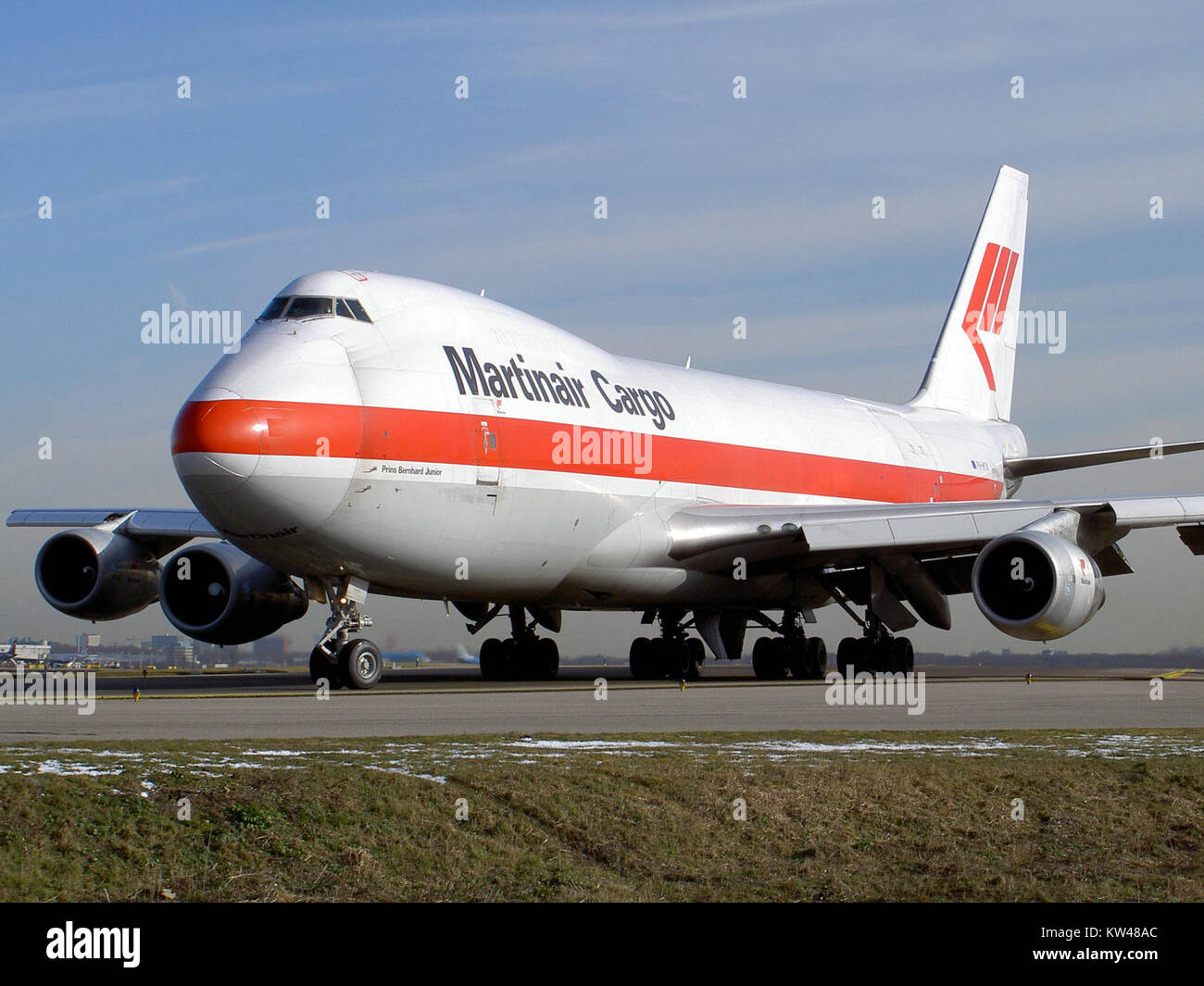 This image features a Boeing 747 cargo aircraft, operated by Martinair ...