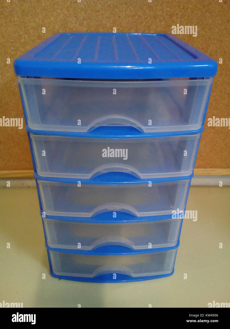 A blue plastic chest of drawers designed for use on a desktop, offering ...