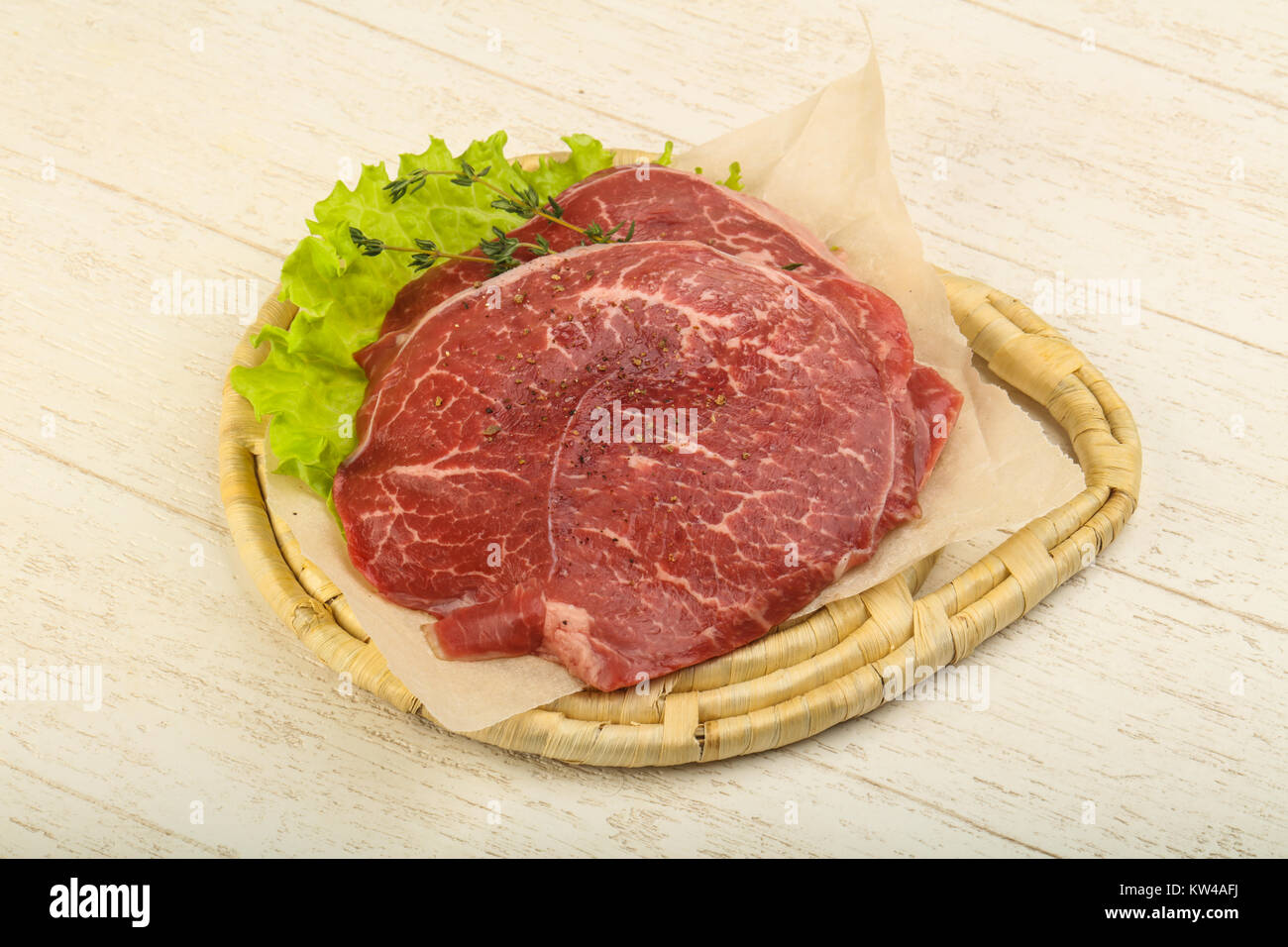 Raw beef schnitzel with spices ready for griil Stock Photo - Alamy