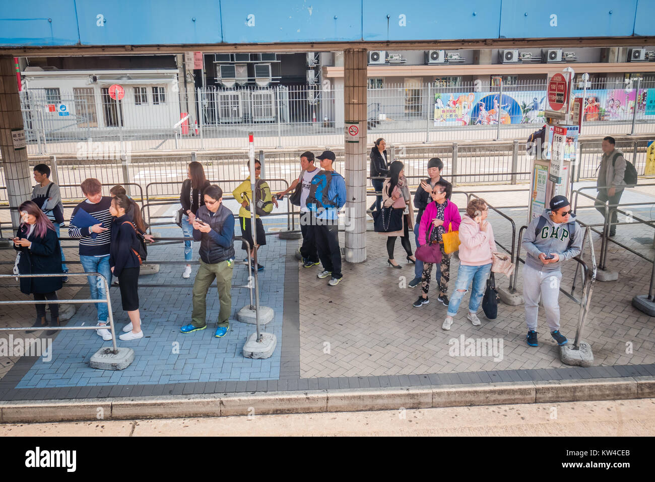 people line up at a bus stop in hong kong Stock Photo - Alamy
