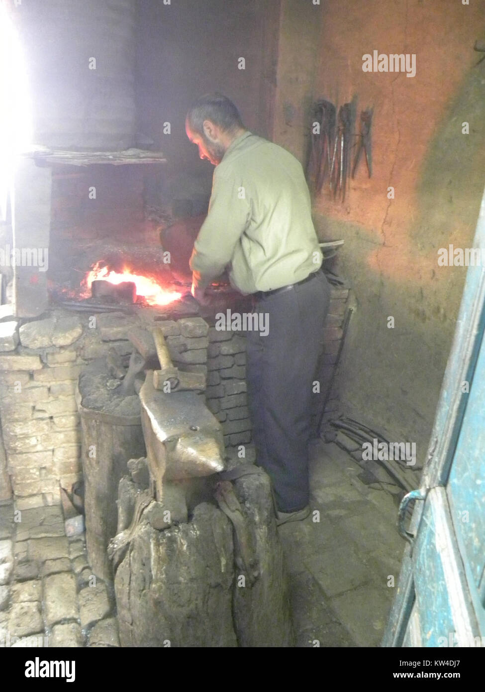 A blacksmith at work in Nishapur, Iran, captured in a moment of ...
