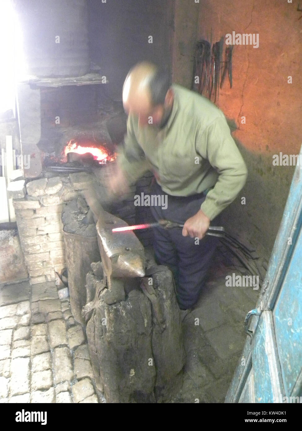 This image depicts a blacksmith working in Nishapur, an ancient city in ...