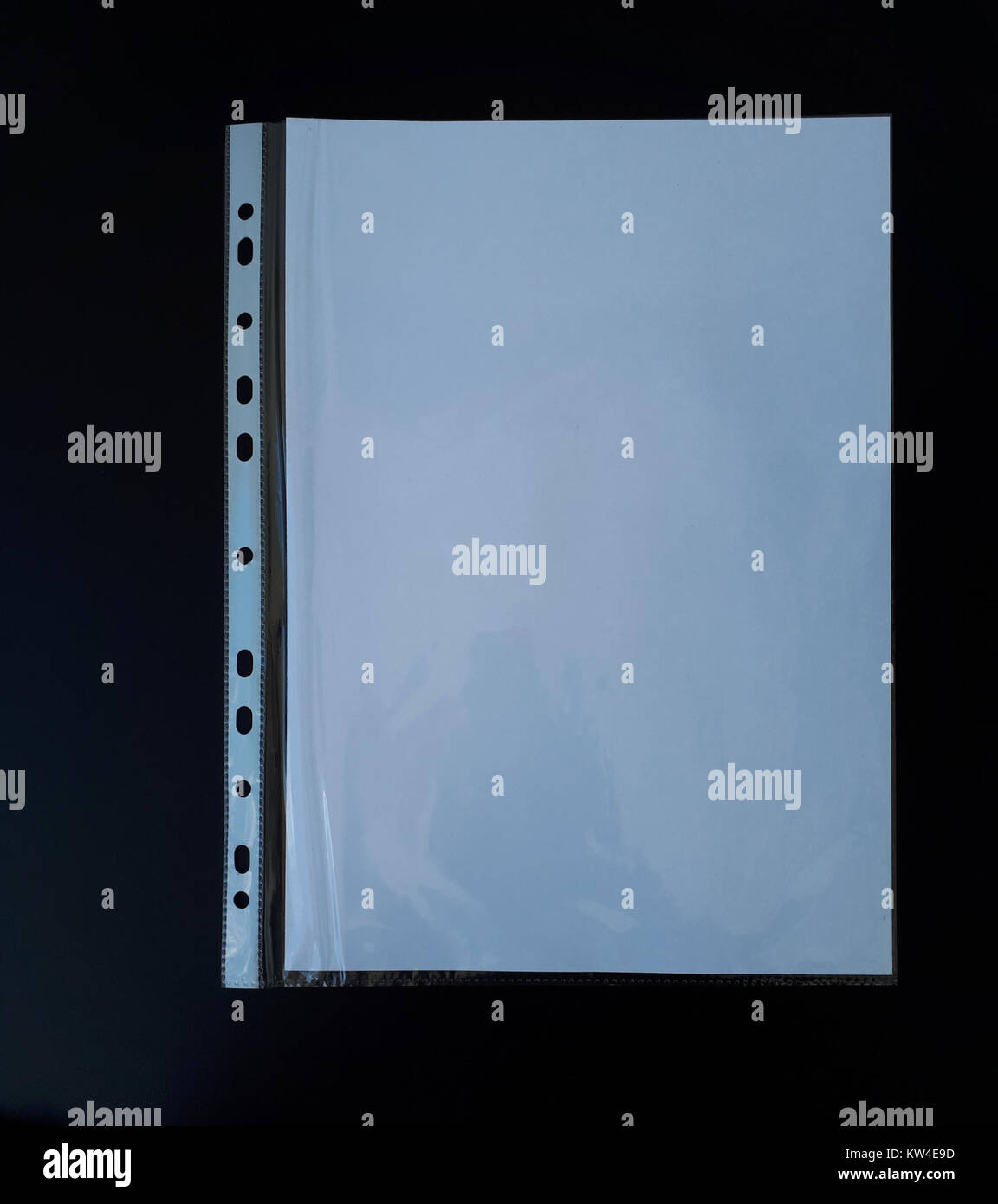 This photograph features a punched pocket with a blue color cast ...