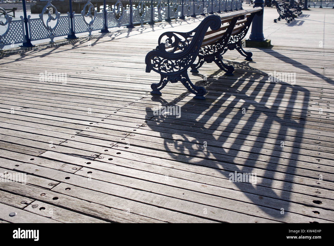 Bench and shadow on a wooden pier Stock Photo - Alamy