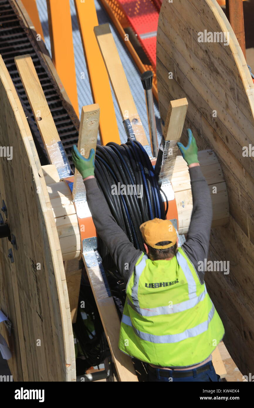 large spool of wire being installed in a liebherr crane, fenit, pier ...