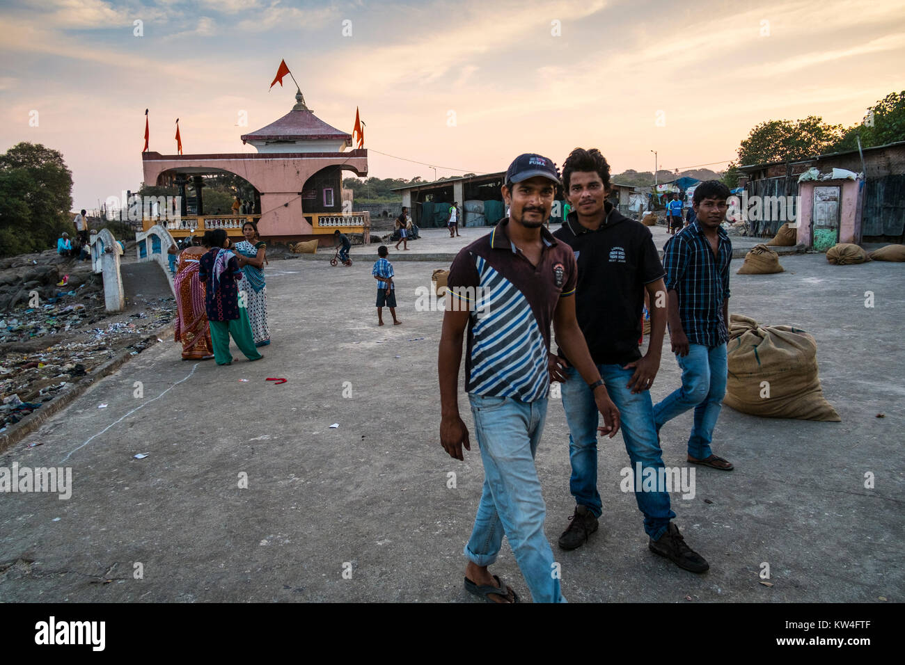 Young men pose for the camera oblivious of the garbage around them near ...