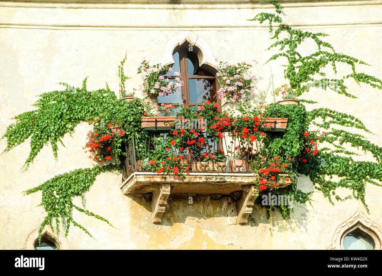 Attractive floral display on upper window balcony on Lake Garda house ...