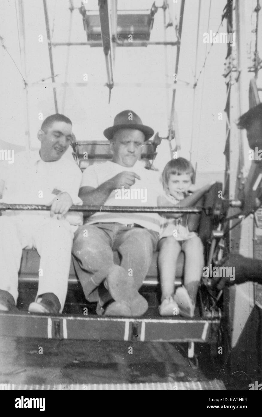 Two men and a young girl on a Ferris wheel at the Monroe County Fair ...