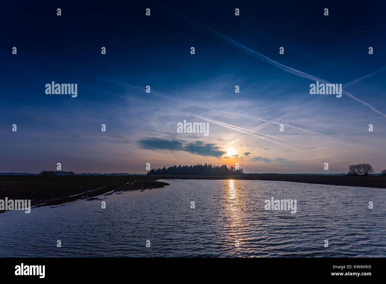 Cold blue evening sunset over the surface of water Stock Photo - Alamy