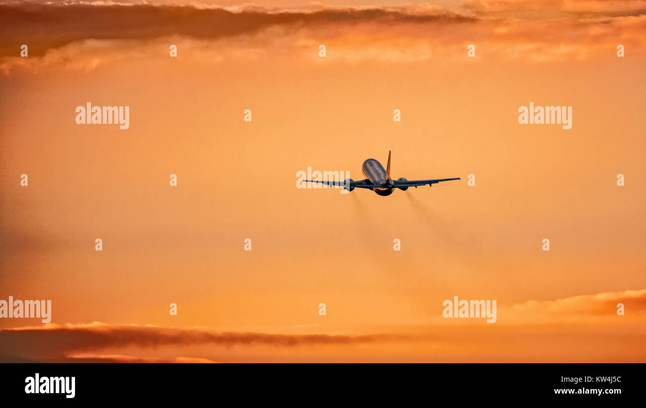 Airplane in the air and sunset in background Stock Photo - Alamy